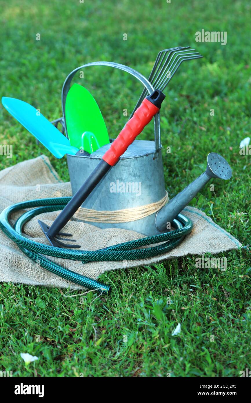 Garden tools on green grass background Stock Photo - Alamy