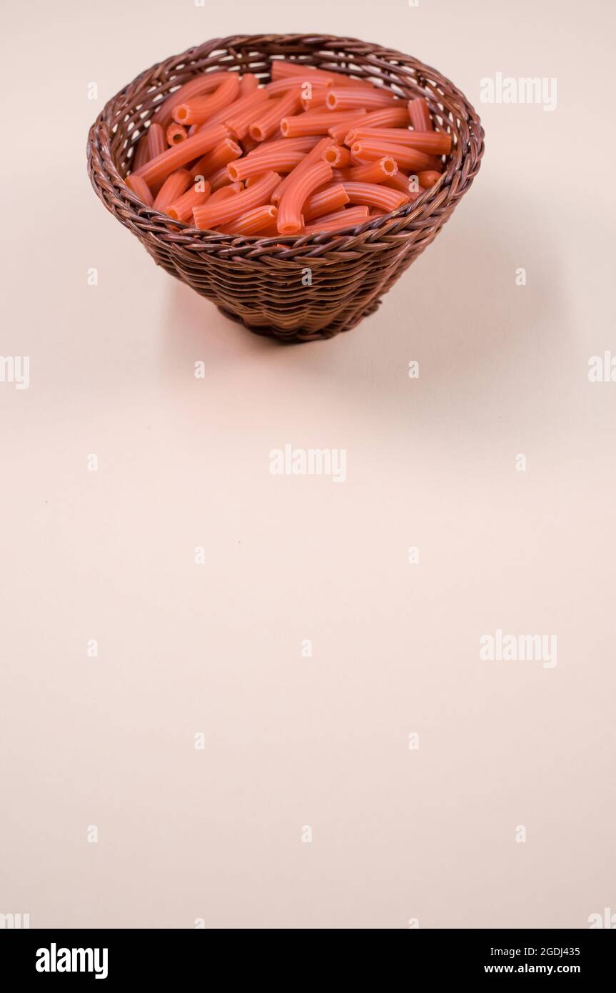 Vertical shot of macaroni on a light pink background Stock Photo - Alamy