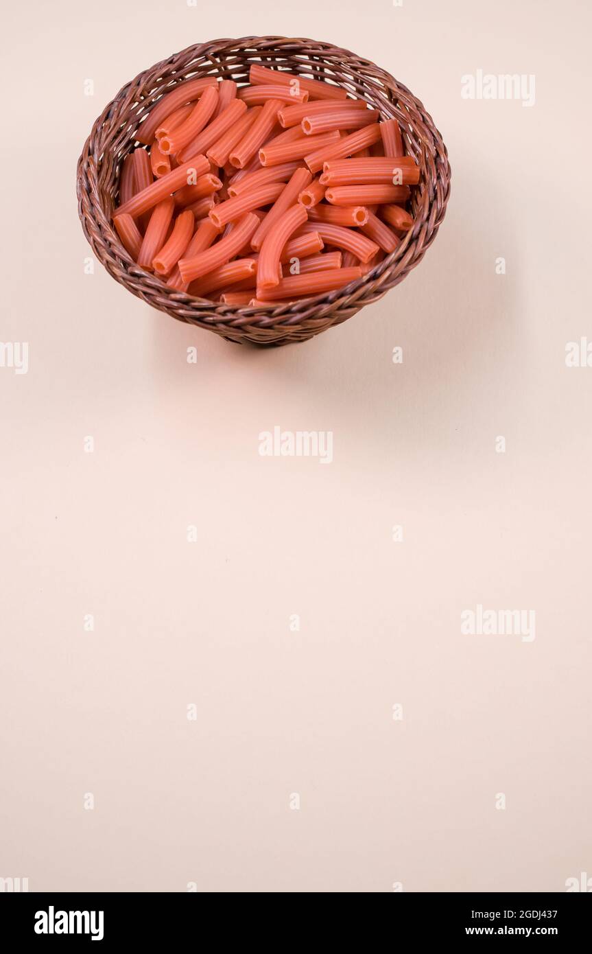 Vertical shot of macaroni on a light pink background Stock Photo - Alamy