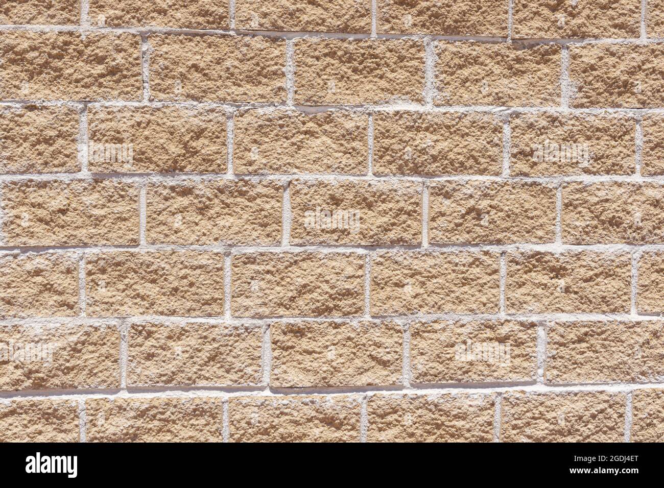 Closeup of a rough textured prefabricated brown concrete block wall ...