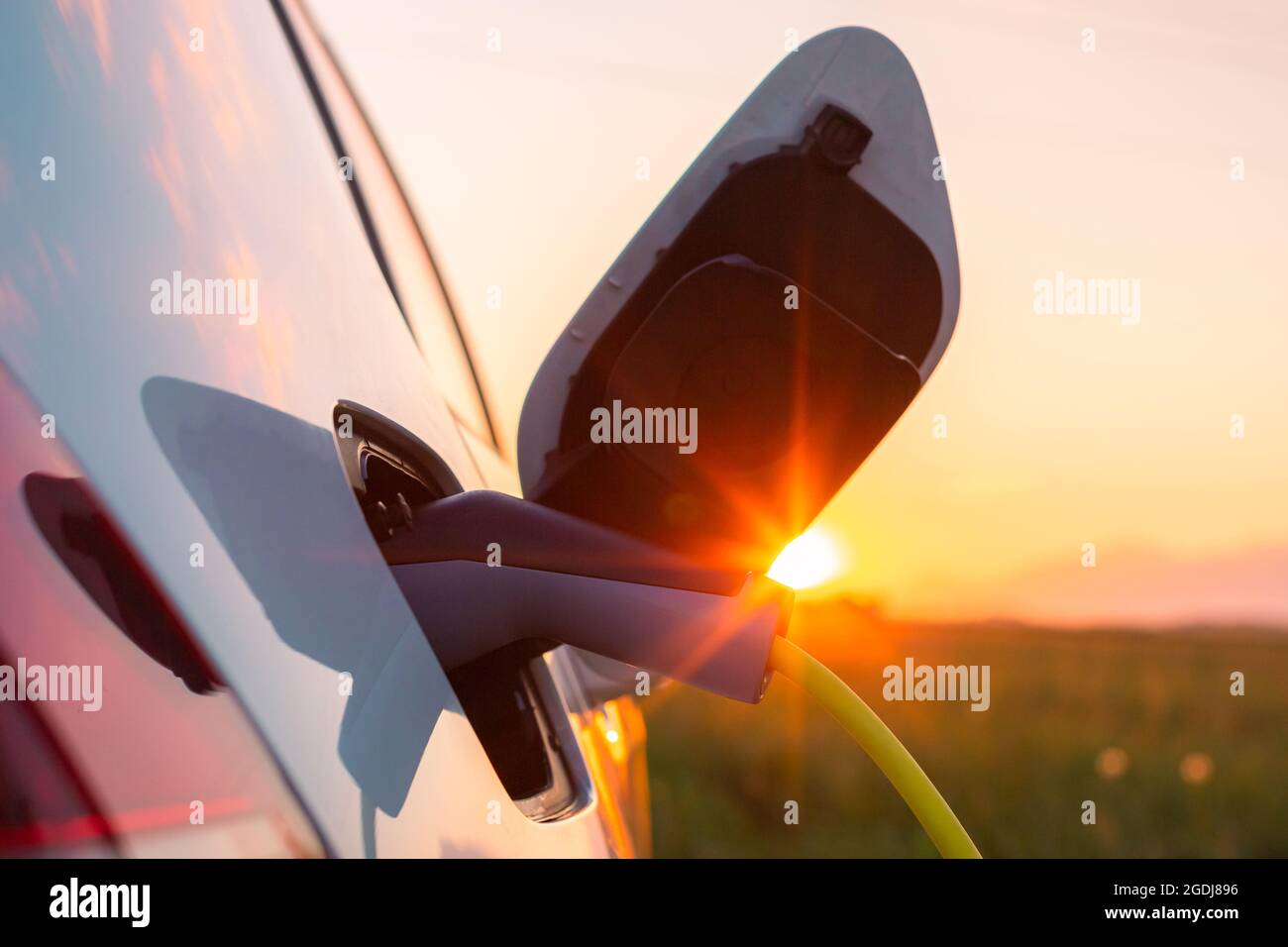 Close up shot of an opened electric car charging socket cap and charger ...