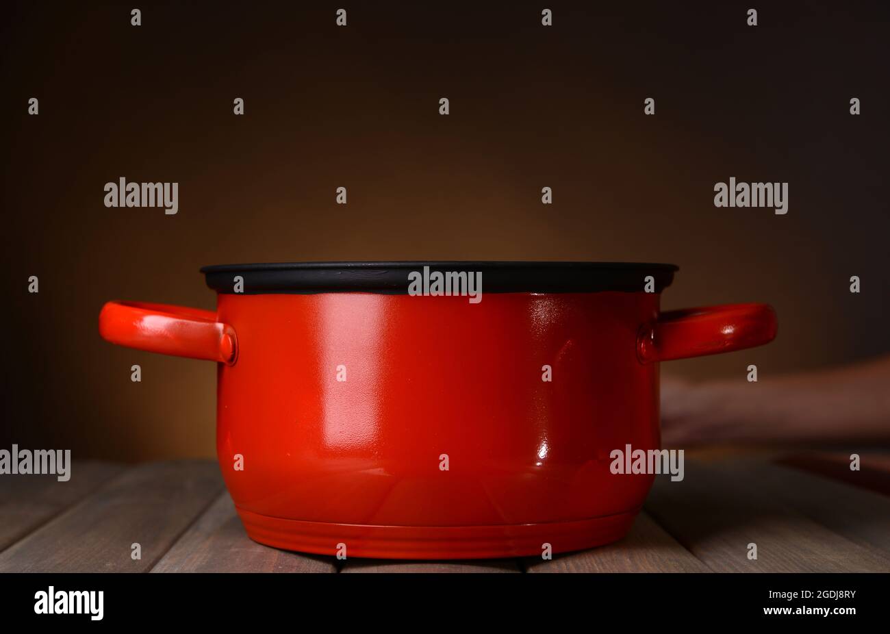 Cooking pot with steam on table on brown background Stock Photo - Alamy