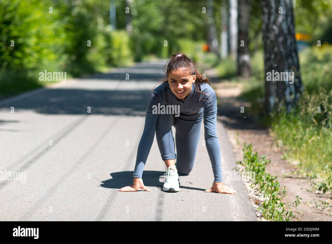 Athletic woman on track starting to run. Jogging pretty girl Stock ...
