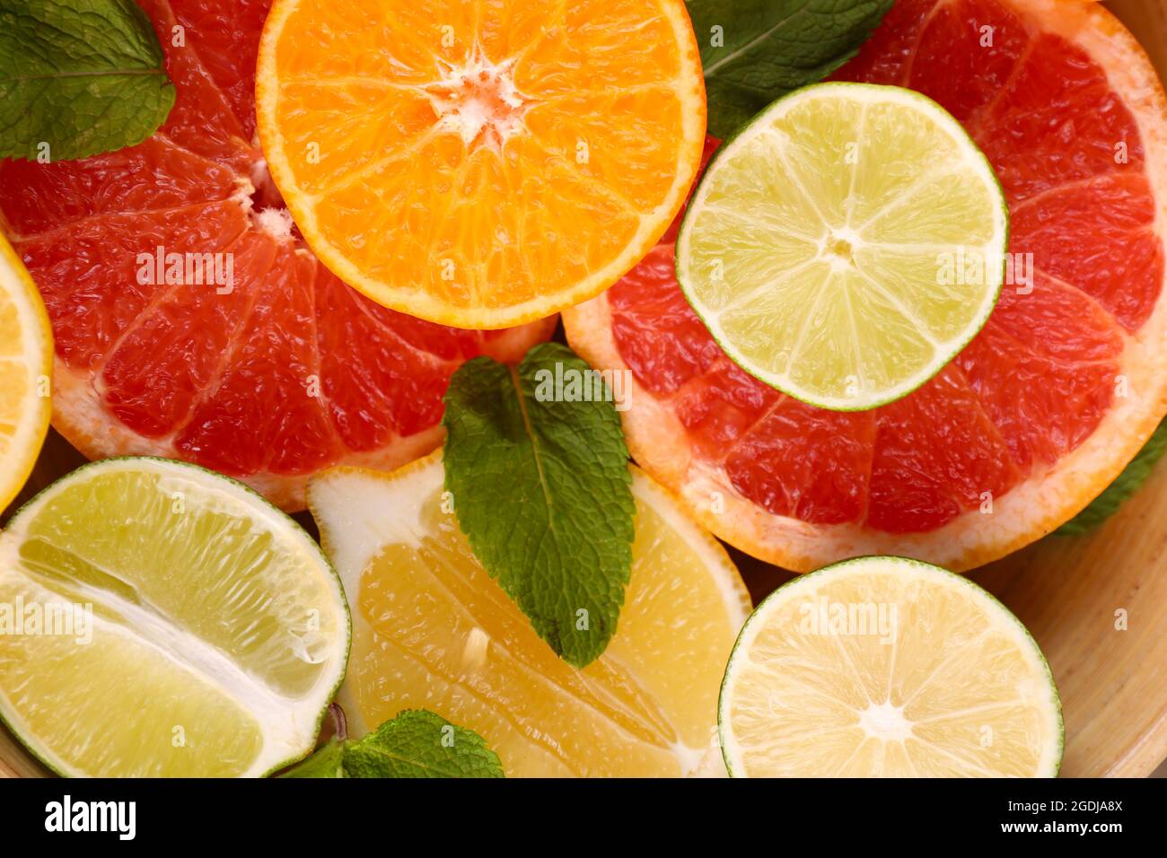 Different sliced juicy citrus fruits, close up Stock Photo - Alamy