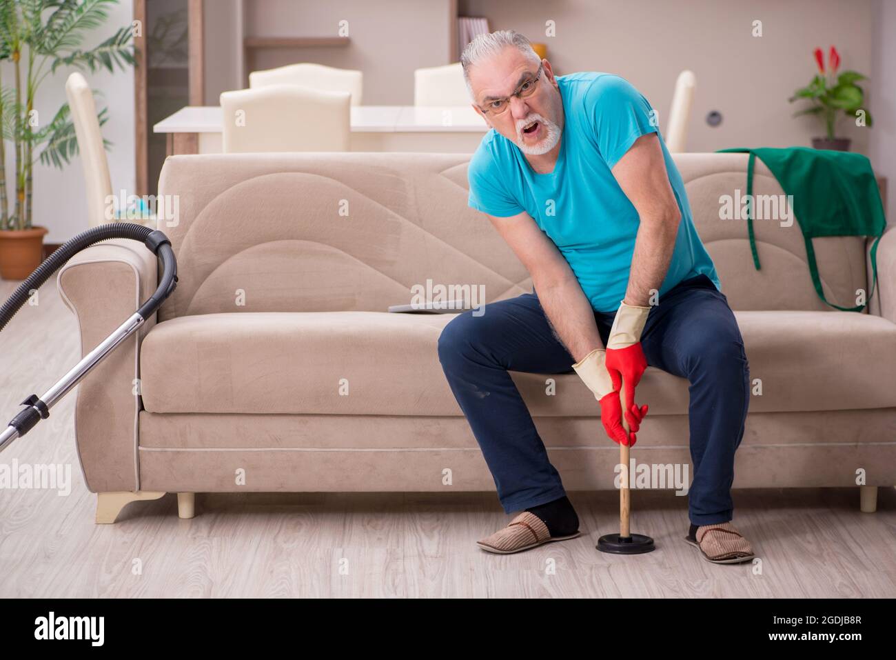 Aged man doing plumbing at home Stock Photo - Alamy