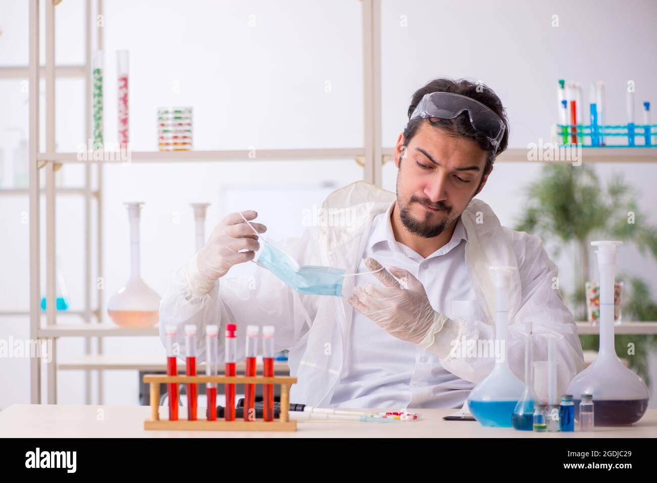 Young chemist extremely tired at the lab Stock Photo - Alamy