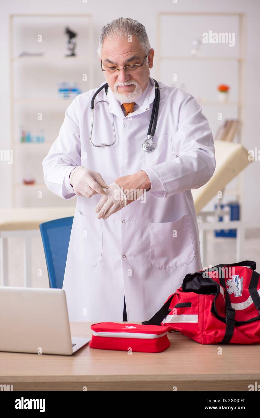 Old doctor in first aid concept Stock Photo - Alamy