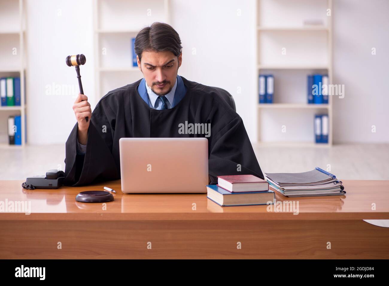 Young judge working in the courtroom Stock Photo - Alamy