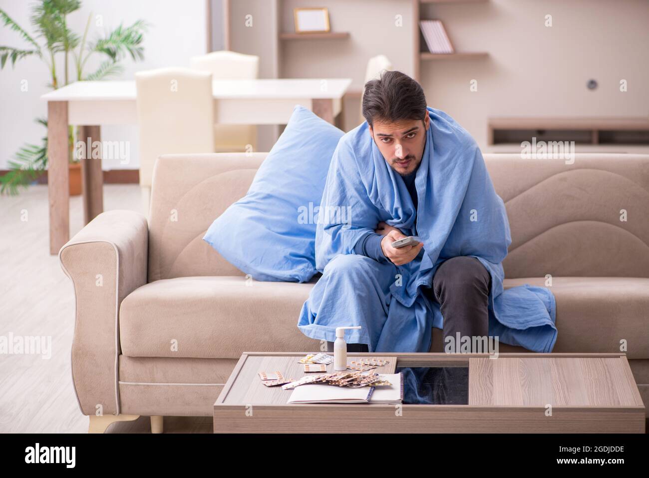 Young man feeling bad at home during pandemic Stock Photo - Alamy