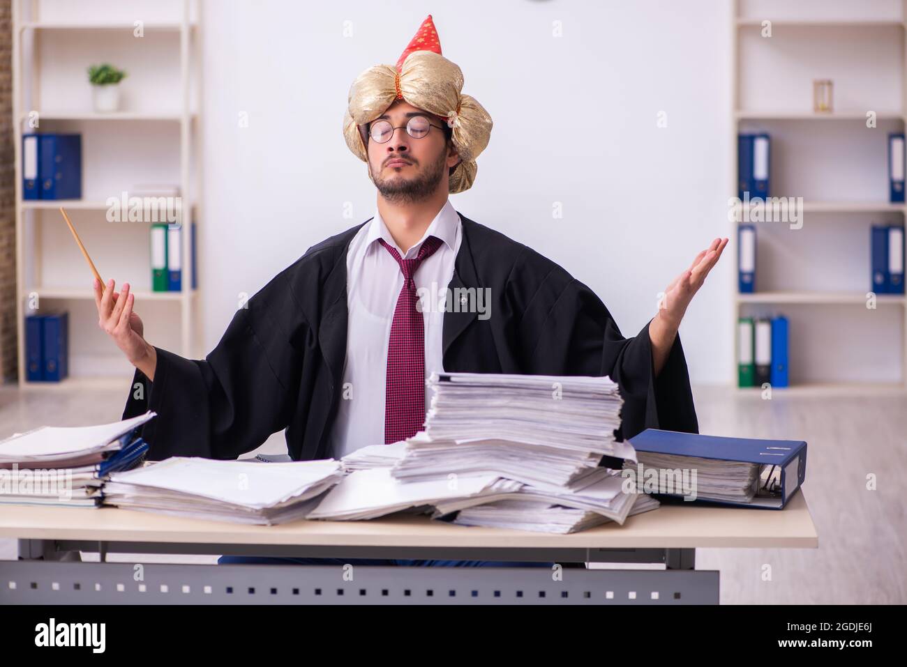 Funny young employee magician and too much work in the office Stock ...