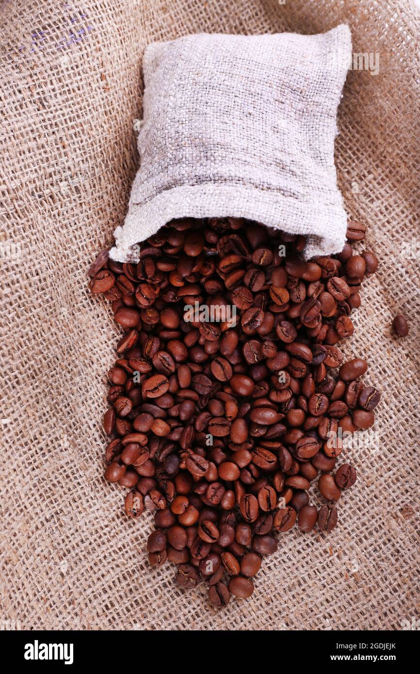 Coffee beans on sacking background Stock Photo - Alamy