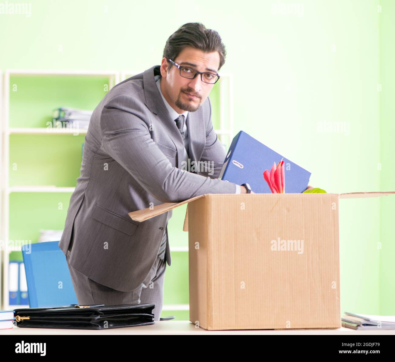 The male employee collecting his stuff after redundancy Stock Photo - Alamy