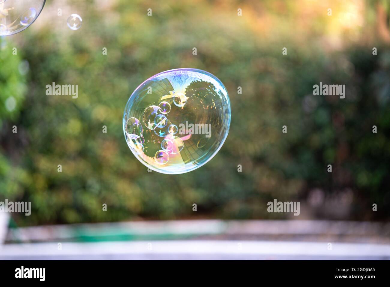 Soap bubble floating in the air Stock Photo - Alamy