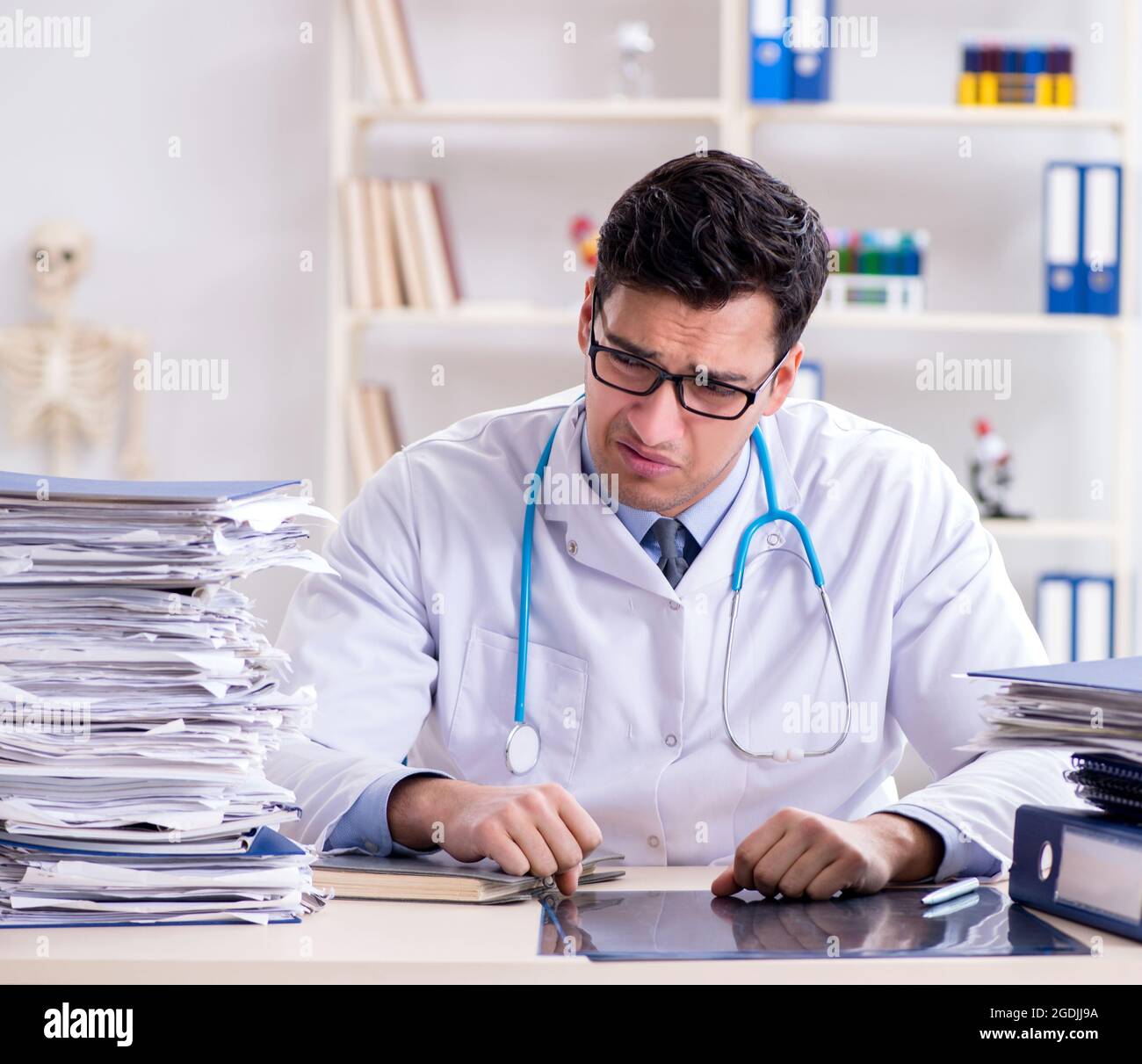 The busy doctor with too much work in hospital Stock Photo - Alamy