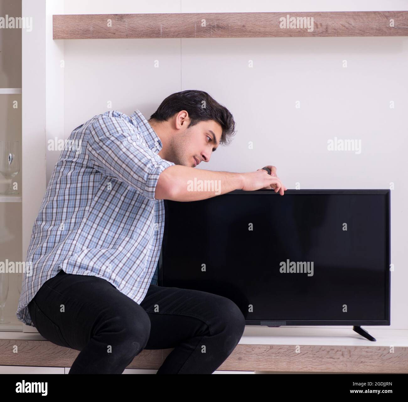 The man repairing broken tv at home Stock Photo - Alamy