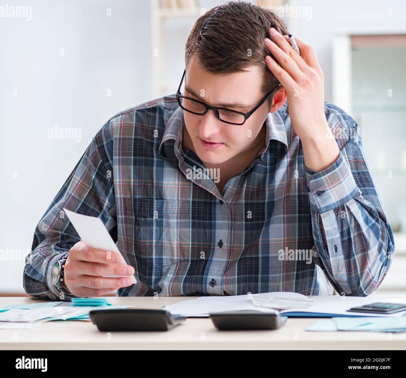 The young man frustrated at his house and tax bills Stock Photo - Alamy