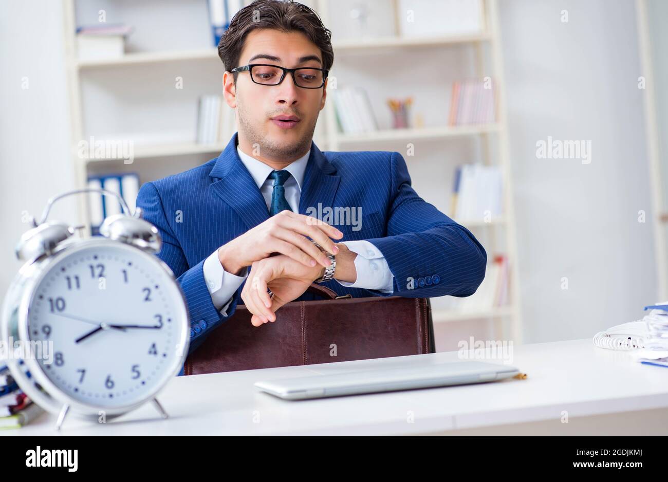 The businessman in bad time management concept Stock Photo - Alamy
