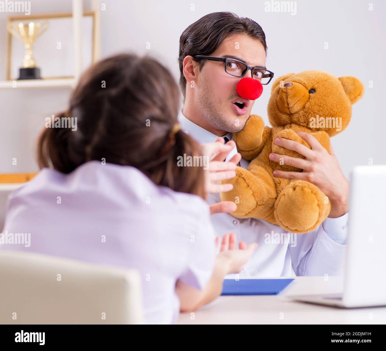 The funny pediatrician with little girl at regular check-up Stock Photo ...