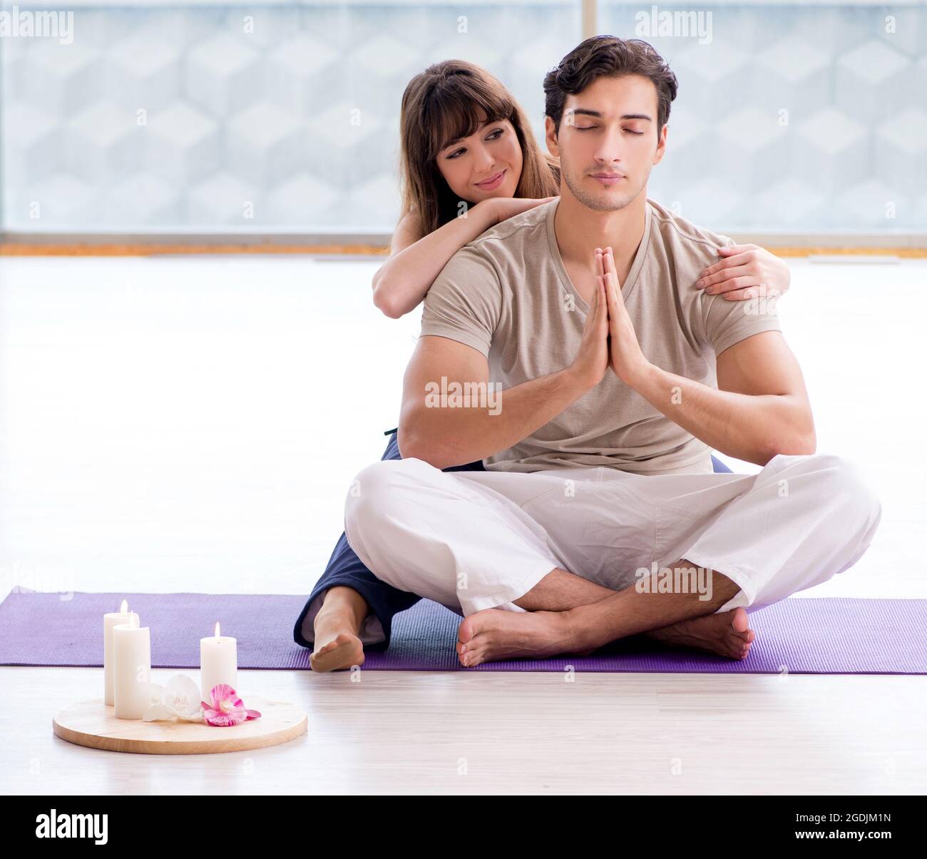 The personal coach helping during yoga session Stock Photo - Alamy