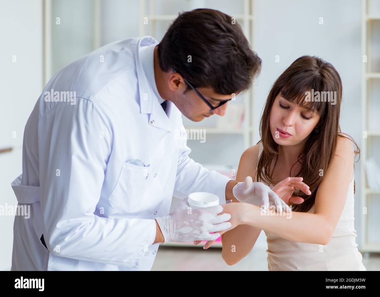 The doctor examining the skin of female patient Stock Photo - Alamy