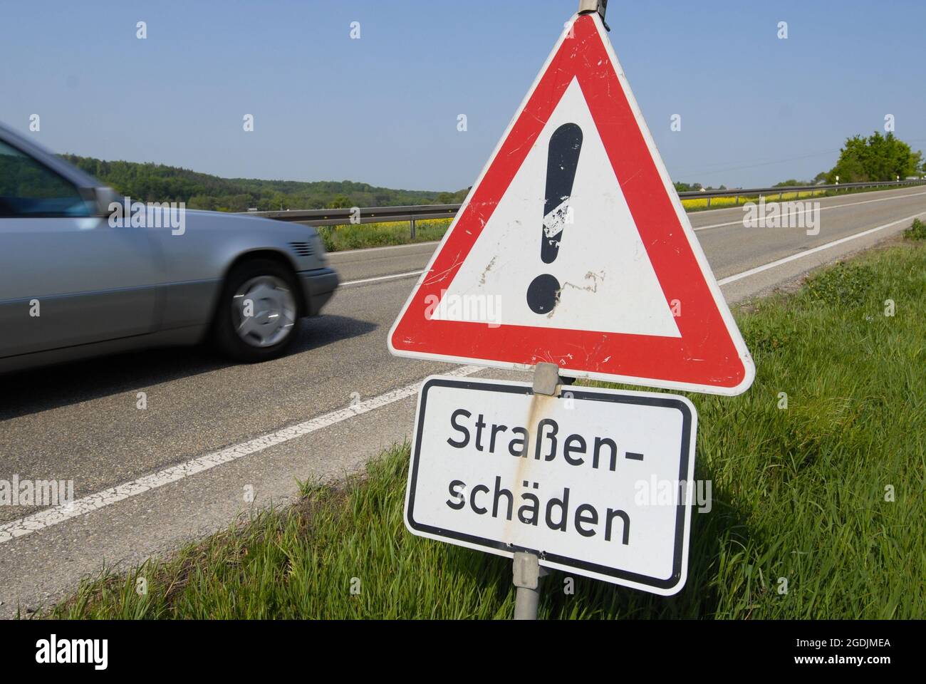 sign 'Caution Road Damage' on the roadside , Germany Stock Photo - Alamy