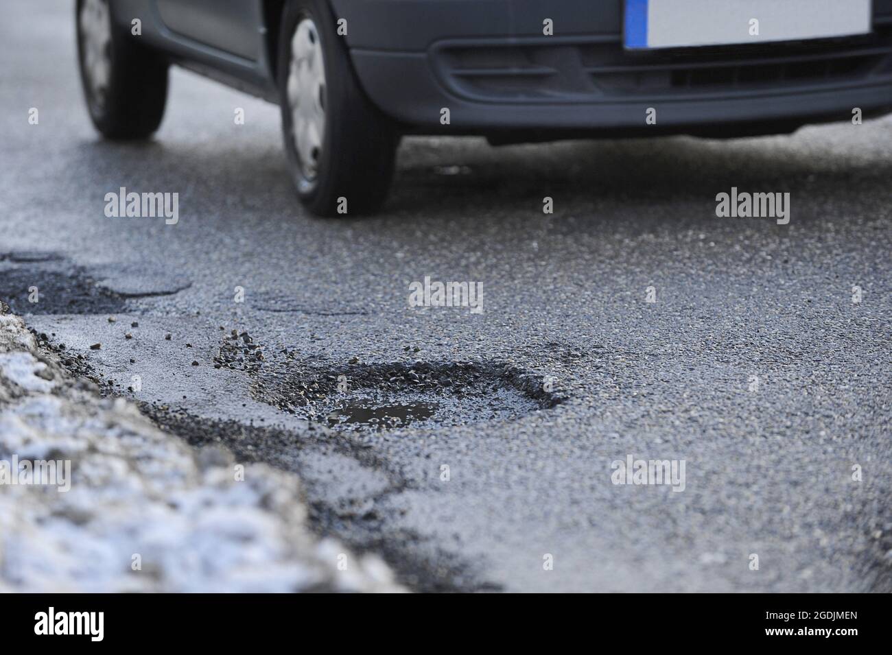 road with potholes after cold winter , Germany Stock Photo - Alamy