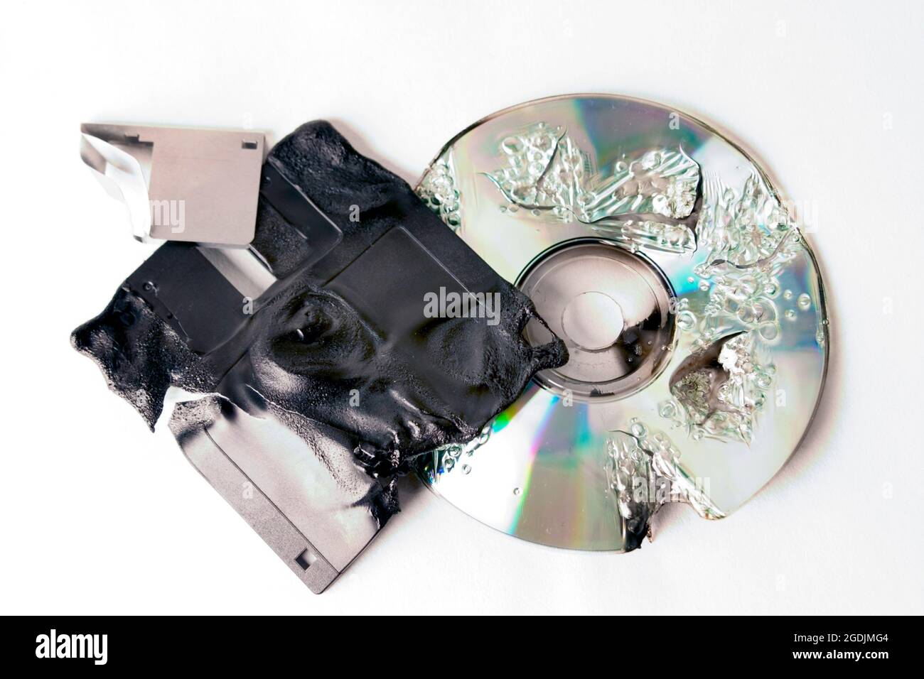 loss of data, melted CD and diskette Stock Photo - Alamy