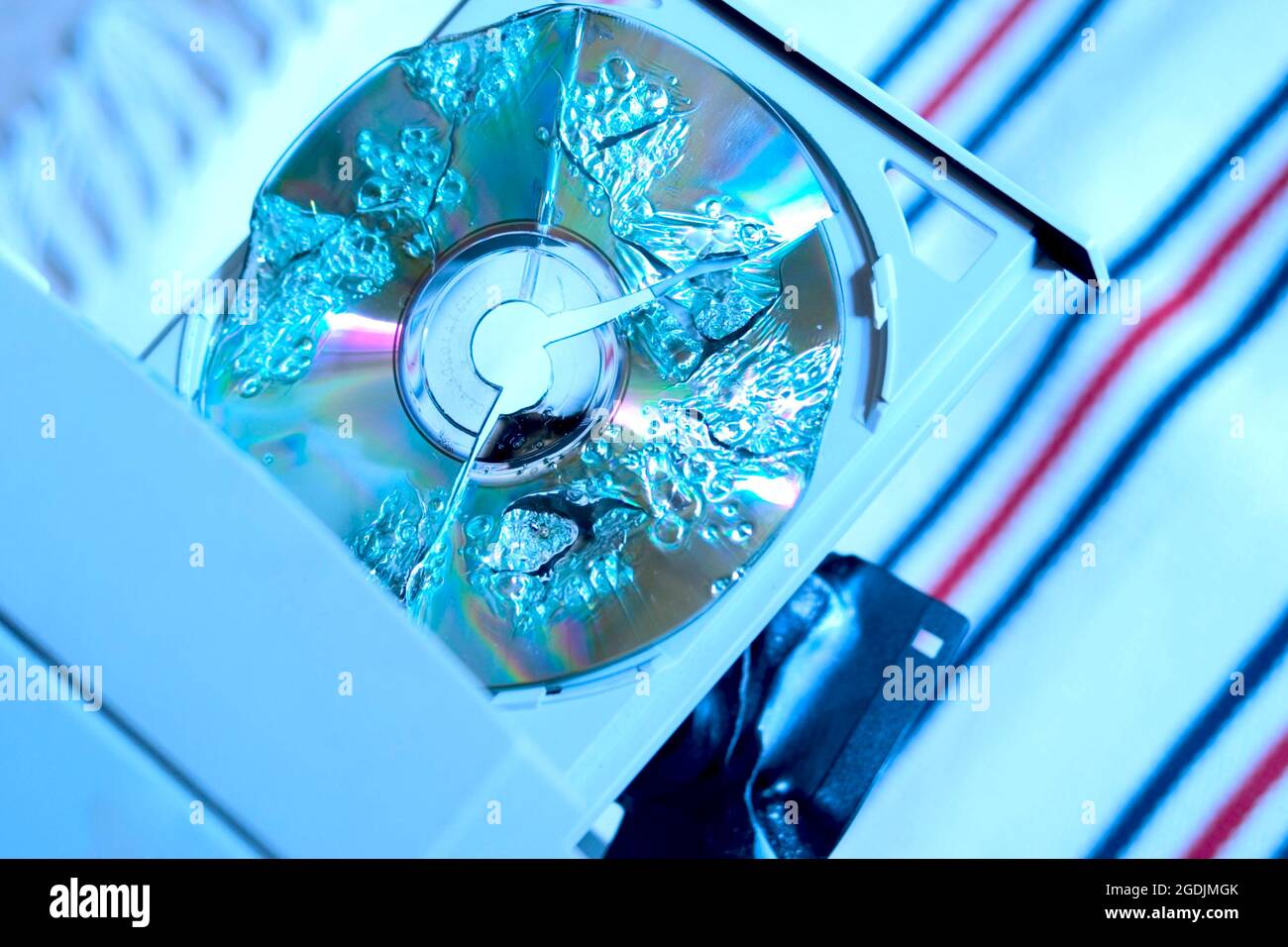 loss of data, melted and broken DVD in a DVD drive Stock Photo - Alamy