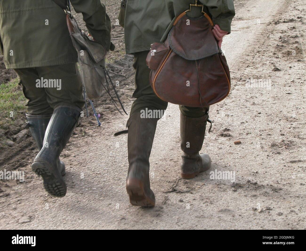 two hunters walking together on a field path, rear view, Austria Stock ...