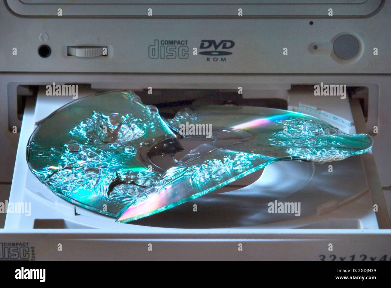 loss of data, melted DVD in a DVD drive Stock Photo - Alamy