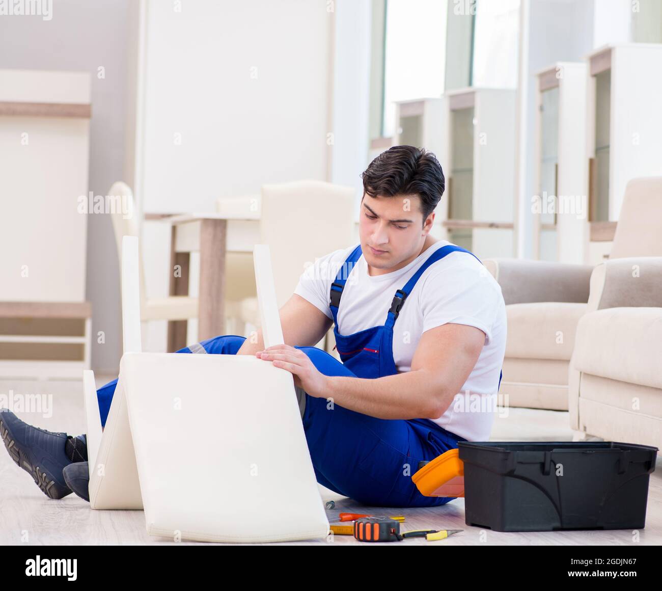 The furniture repairman working in store Stock Photo - Alamy