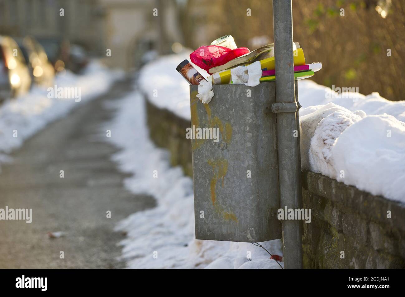 overfilled dustbin on a sidewalk in winter , Germany Stock Photo - Alamy