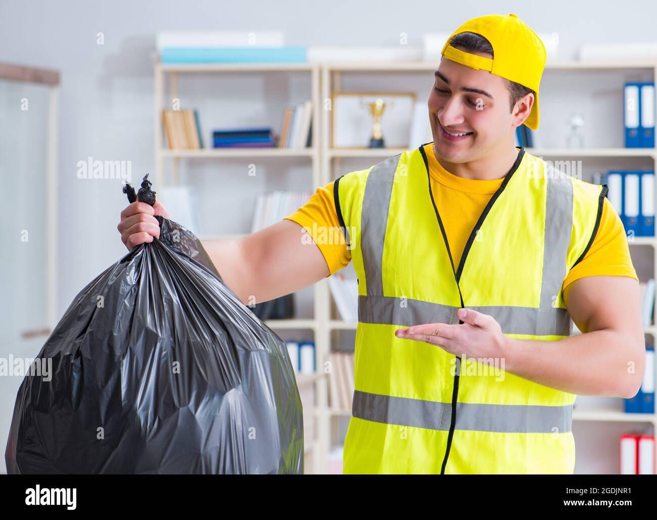 The man cleaning the office and holding garbage bag Stock Photo - Alamy