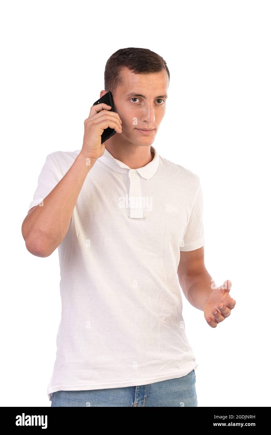 Young man making a phone call with a mobile phone on a white background ...