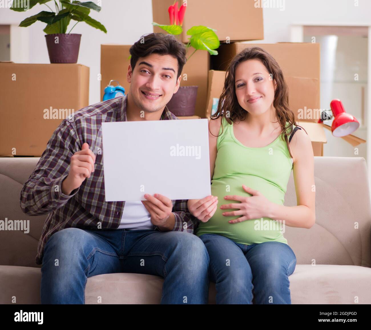 The young couple expecting baby with blank message Stock Photo - Alamy