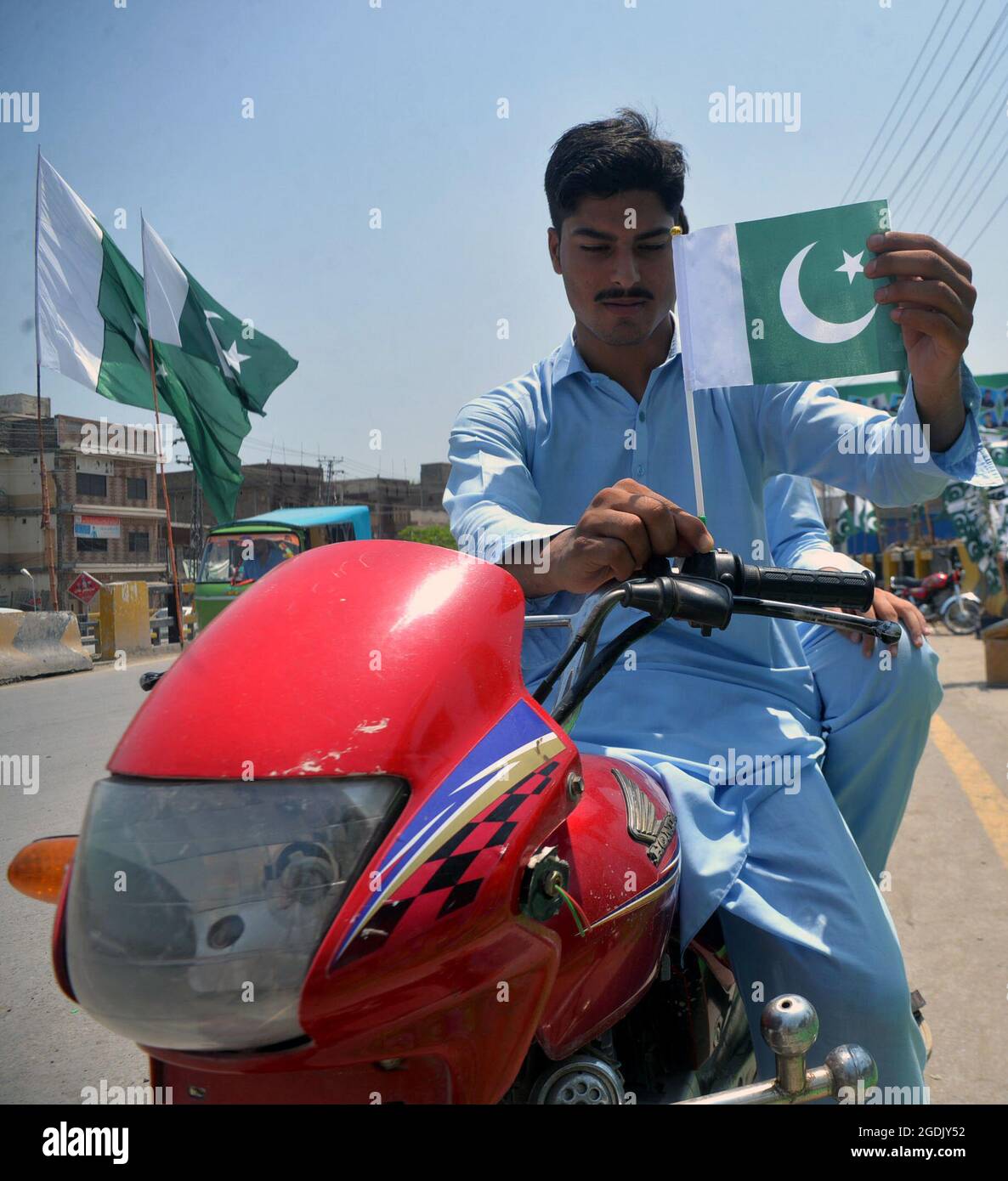 Peshawar, Pakistan. 13th Aug, 2021. A man puts a Pakistan's national ...