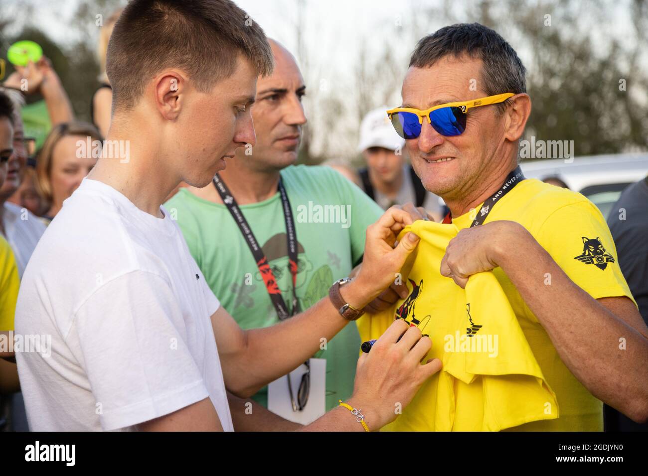 Two-time Tour de France winner Tadej Pogacar signs an autograph for his ...