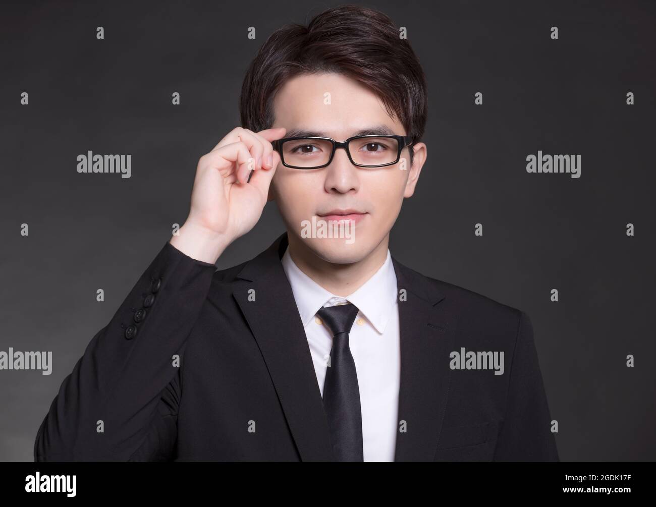 Smiling businessman wearing black suit hi-res stock photography and ...