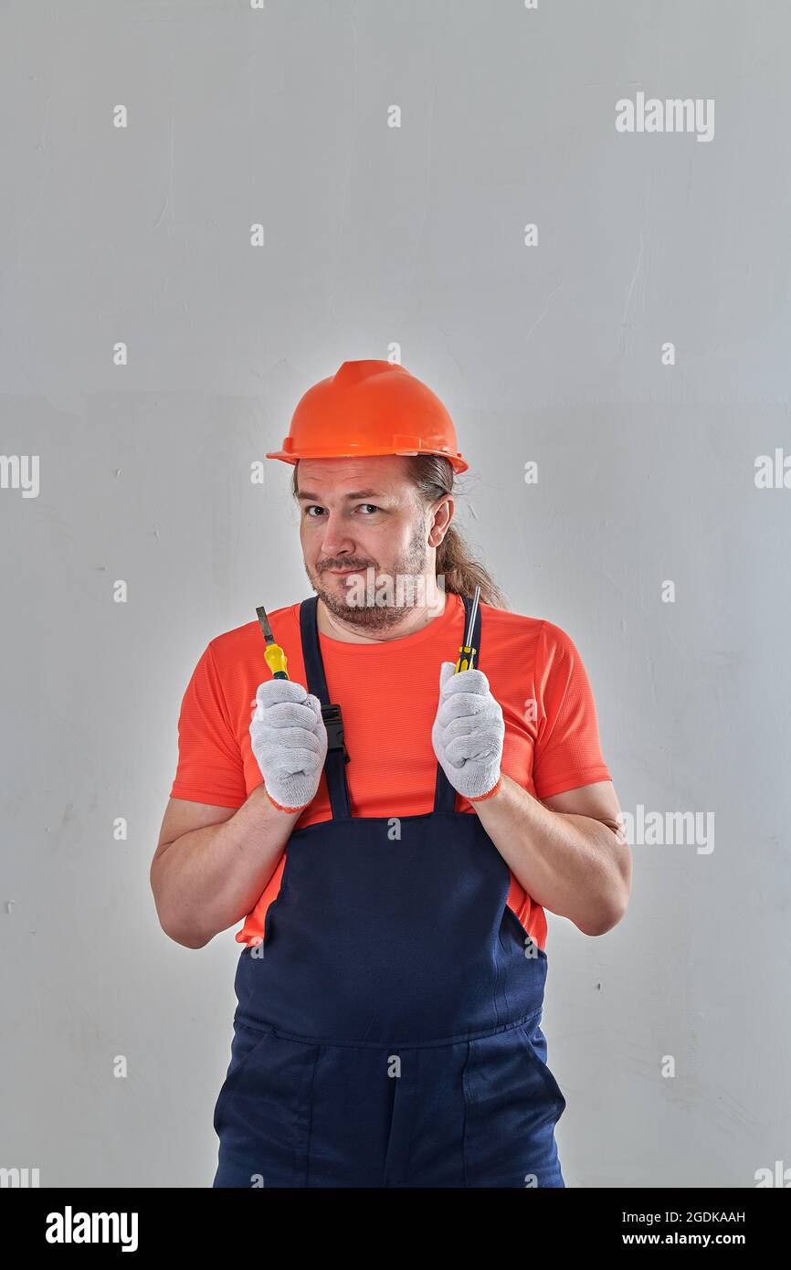 very cheerful chief engineer stands with tools Stock Photo - Alamy