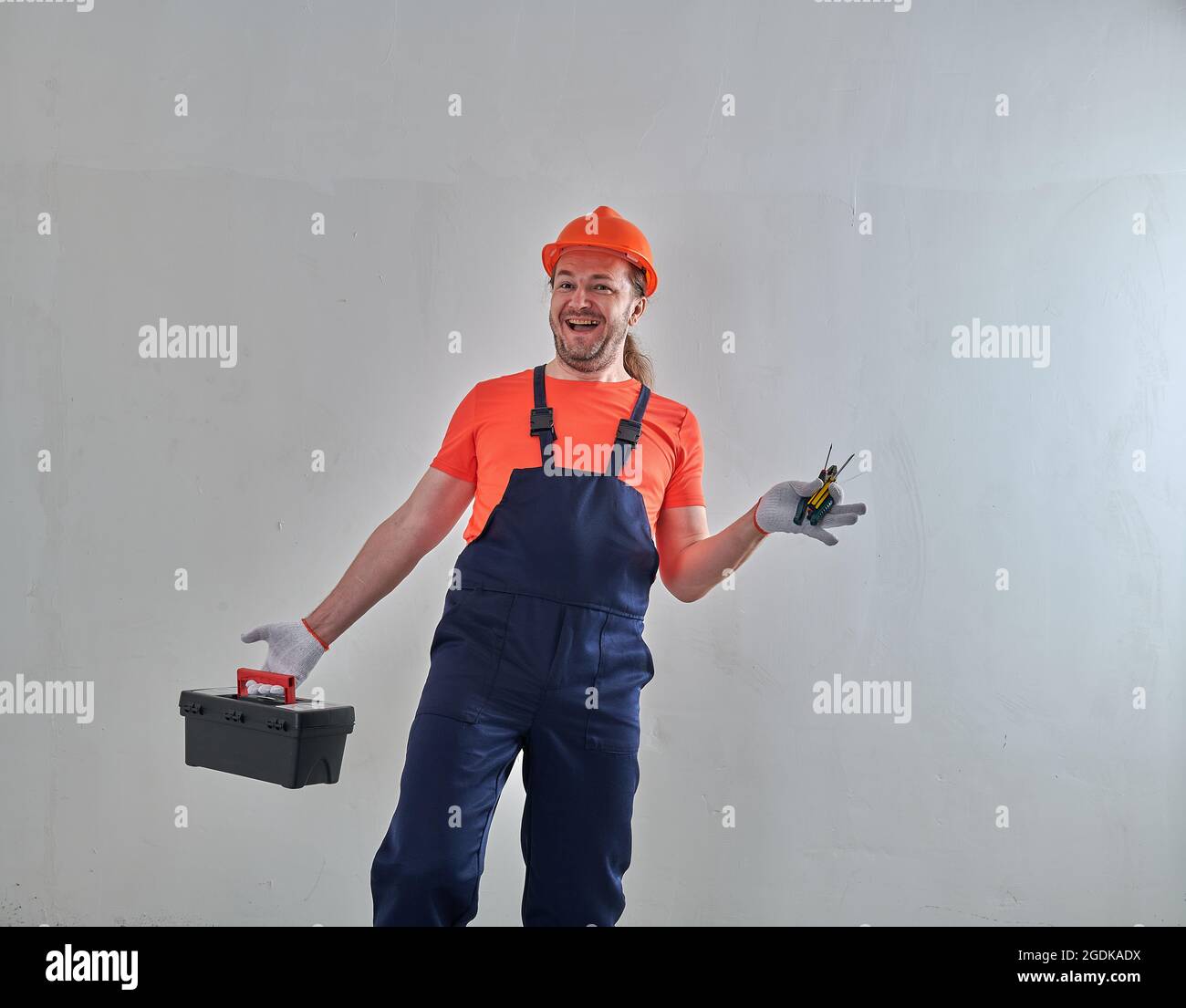 funny repairman with tools stands in the apartment Stock Photo - Alamy