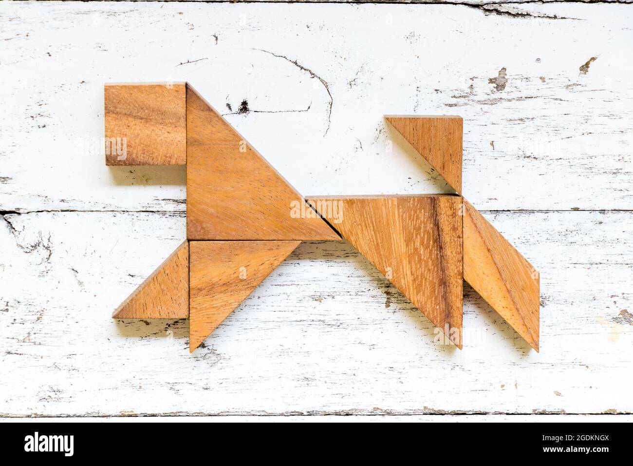 Tangram puzzle in running dog shape on old white wood background Stock ...