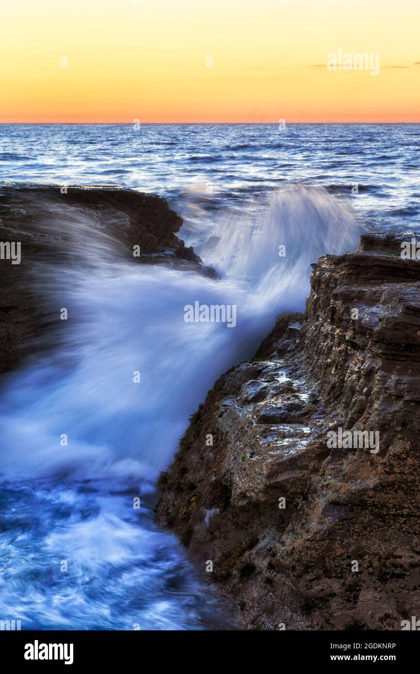 Incoming wave between two sandstone rocks at Sydney Northern beaches ...