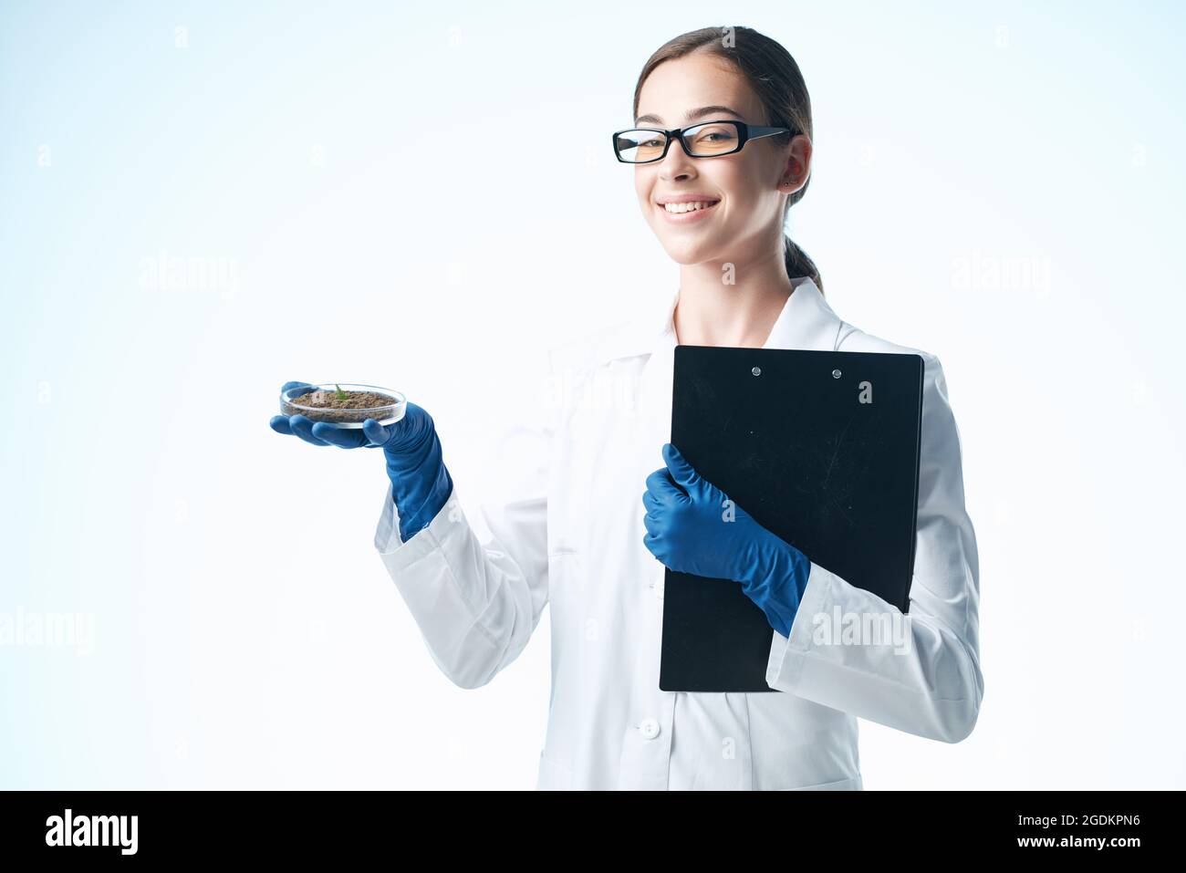 female laboratory assistant in white coat biology research experiment ...