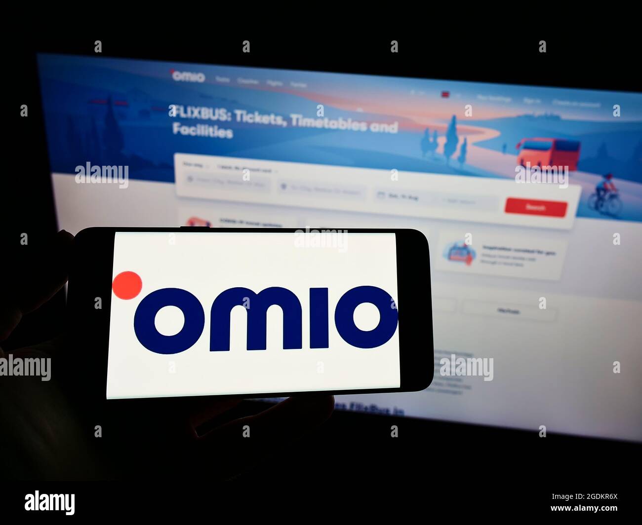 Person holding cellphone with logo of German travel company GoEuro Corp ...