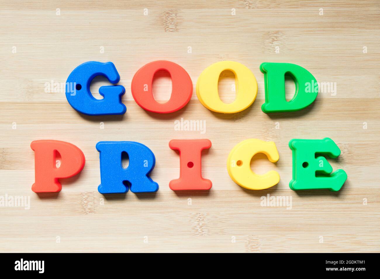 Color plastic alphabet in word good price on wood background Stock ...