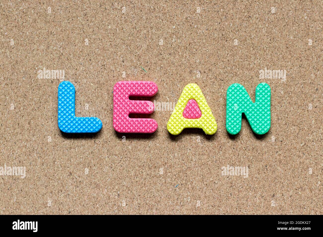 Color foam alphabet in word lean on cork board background Stock Photo ...