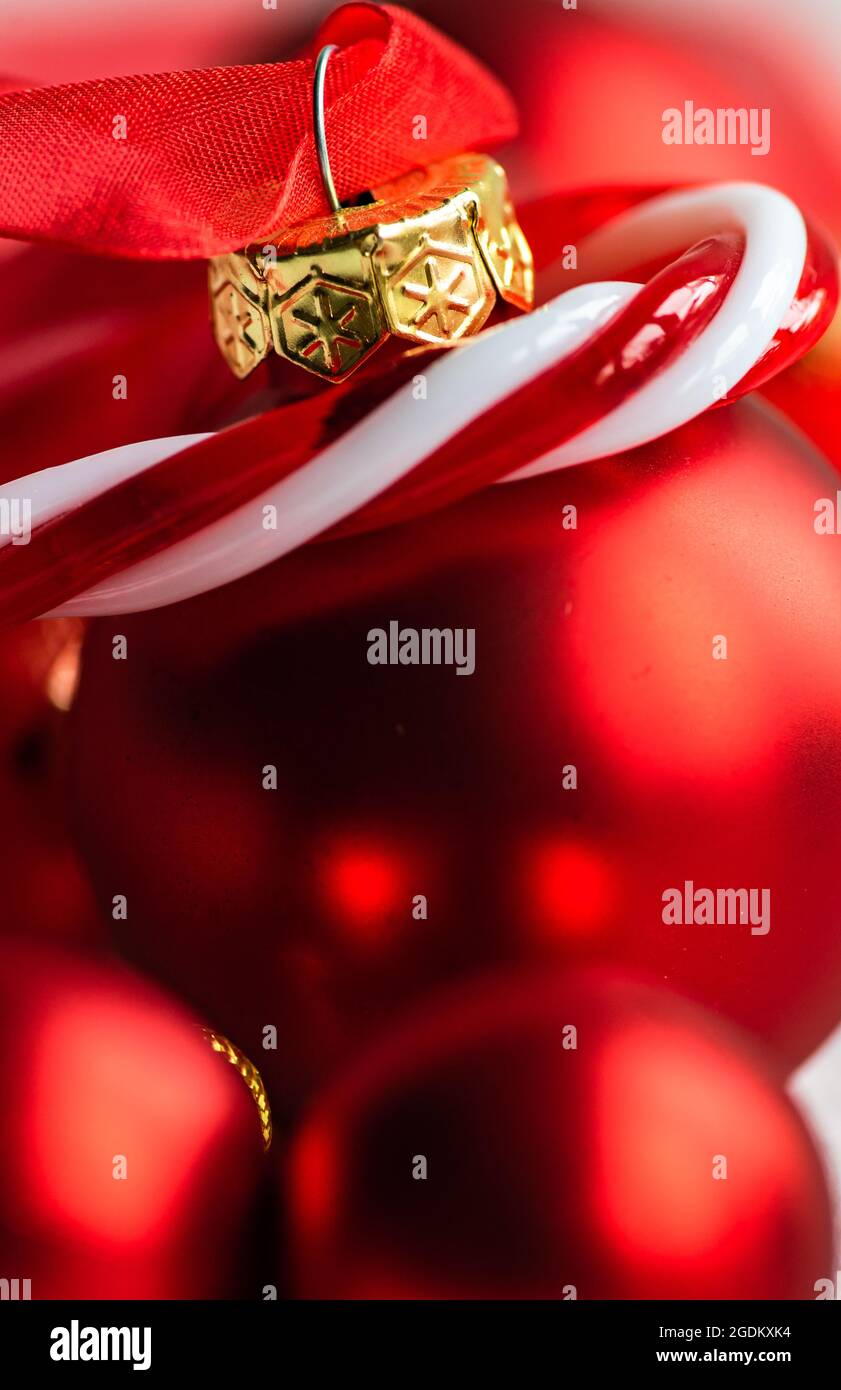 Close up of Christmas card with red ball decoration and cone candy ...