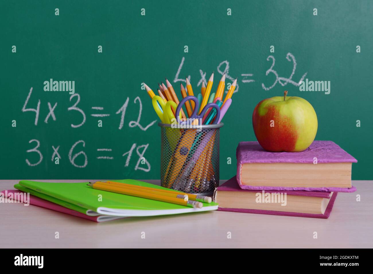 School supplies on table on board background Stock Photo - Alamy