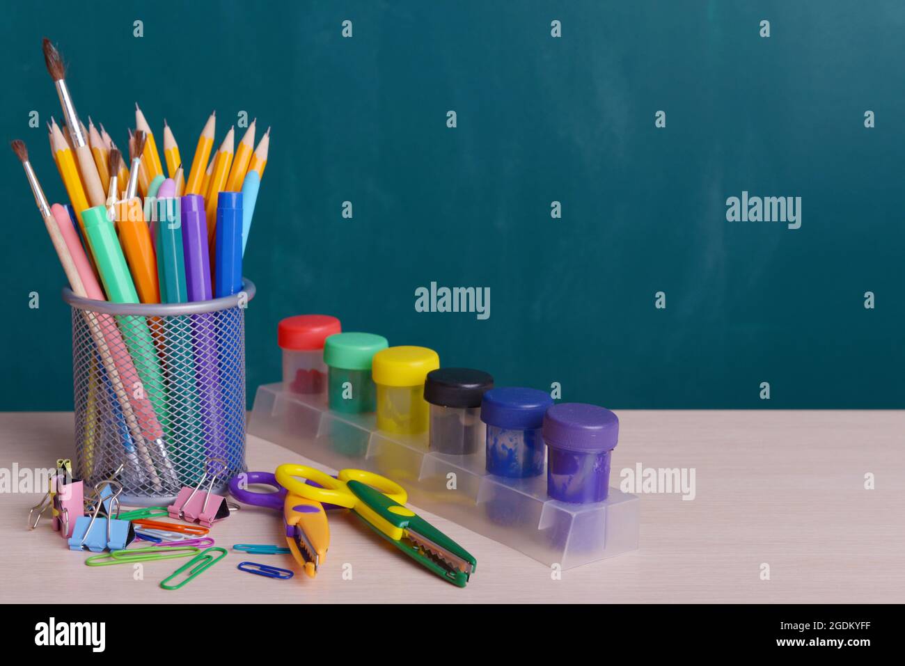 School supplies on table on board background Stock Photo - Alamy