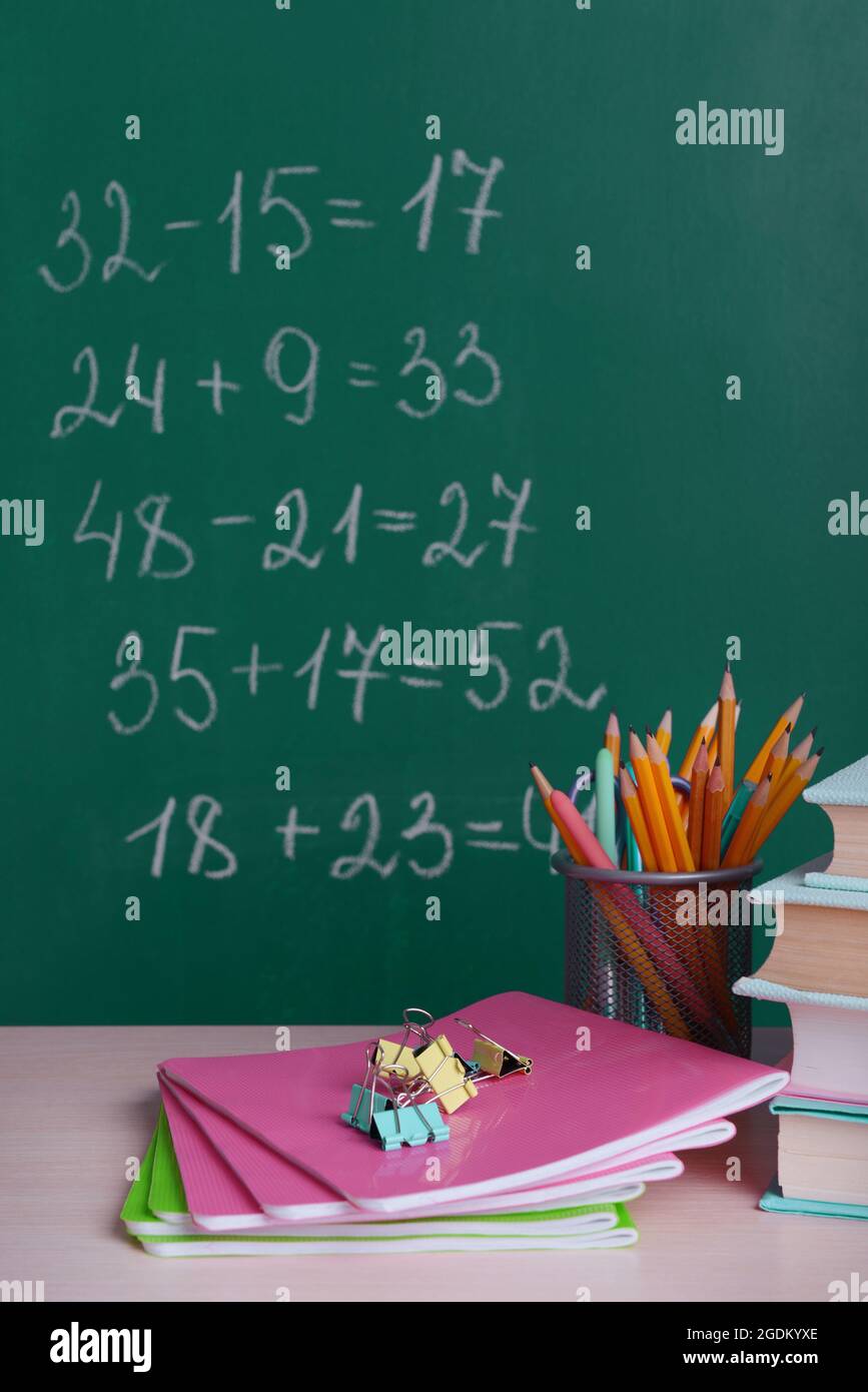 School supplies on table on board background Stock Photo - Alamy